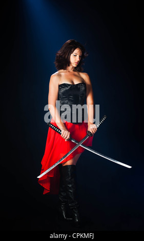 Female assassin in red skirt displays her power Stock Photo - Alamy