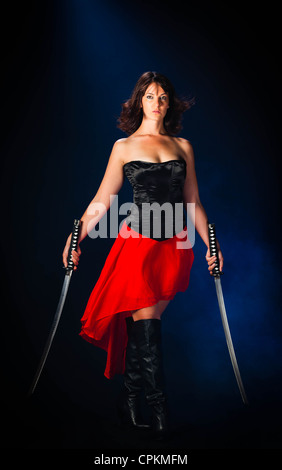Female assassin in red skirt displays her power Stock Photo - Alamy