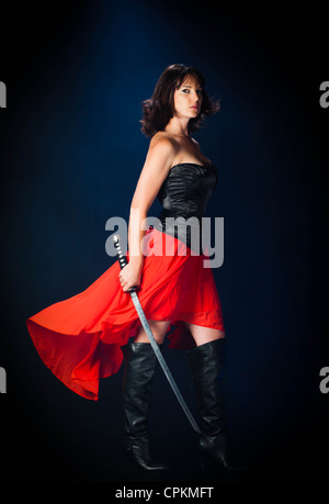 Female assassin in red skirt displays her power Stock Photo - Alamy