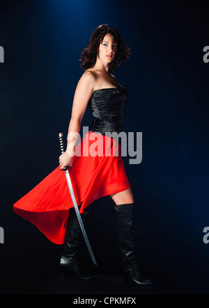 Female assassin in red skirt displays her power Stock Photo - Alamy