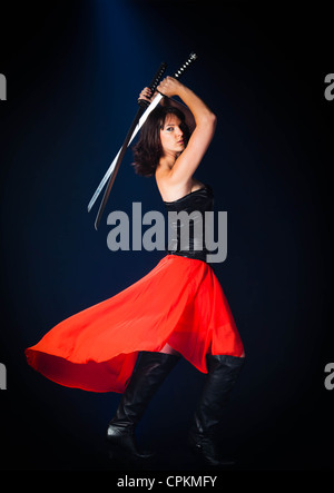 Female assassin in red skirt displays her power Stock Photo - Alamy