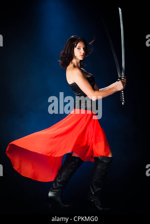 Female assassin in red skirt displays her power Stock Photo - Alamy