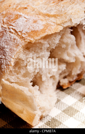 Cut in half a loaf of bread made of dark flour, isolated on white ...