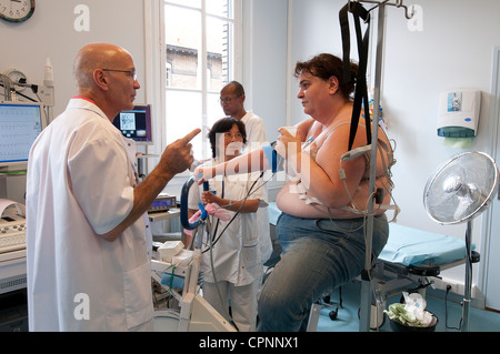 Woman undergoing an electrocardiography (EKG) examination, Department ...