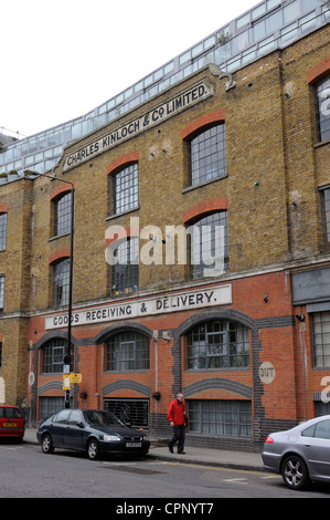 London Docklands. Old warehouse buildings along river Thames with black ...