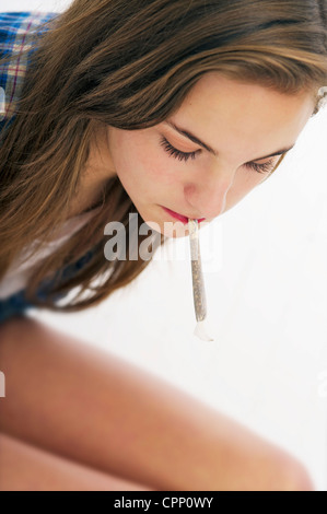 Teenagers smoking marijuana or hashish cigarette and drinking alcohol ...