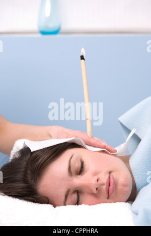 Hopi Ear candle treatment. For calming the mind Stock Photo - Alamy