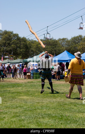 A competitor competing in the Tossing of the Caber contest during the ...