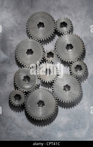 INTERLOCKING COG GEARS WHEELS ON RED GRID Stock Photo - Alamy