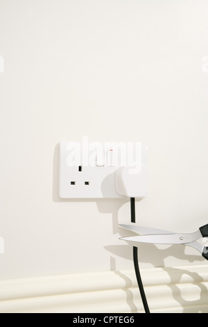 Cutting the electrical cable with scissors Stock Photo - Alamy