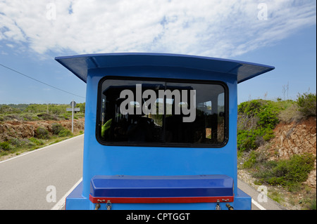 A tourist road train traveling through the streets of St Tropez in ...