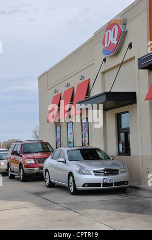 Cars use a drive through window to order and pick up fast food at a ...