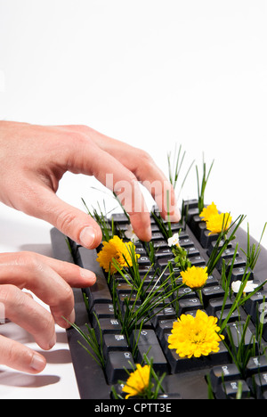 Grass growing from computer keyboard, ecology metaphor Stock Photo - Alamy