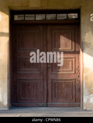 window and damaged wooden doors at vintage building facade Stock Photo ...