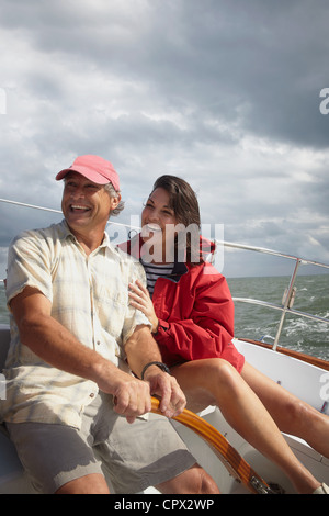 Good-looking mature man sailing a yacht and looking confident Stock ...