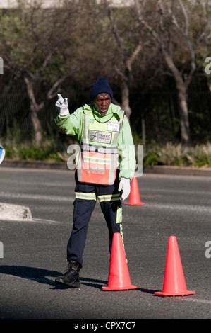 A South African JMPD police officer in riot gear holding police tape ...