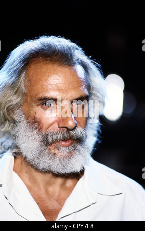 Greek singer and composer Georges Moustaki, plays his guitar as he ...