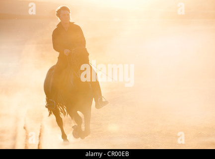 man riding running horse in barrel race at rodeo Stock Photo - Alamy