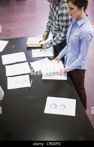 young businesspeople looking at graph of high-tech image Stock Photo ...