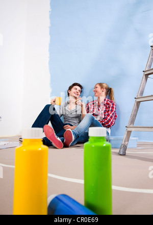 Young couple taking a break drinking a cup of coffee, very happy for ...
