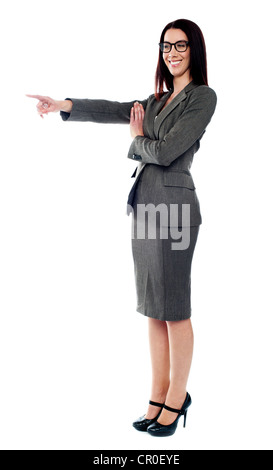 Attractive young woman pointing to the side. All on white background ...