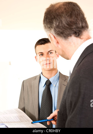 Boss controlling the contract of an employee Stock Photo - Alamy