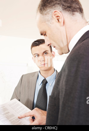 Boss controlling the contract of an employee Stock Photo - Alamy