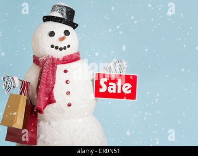 Studio shot of snowman with shoppings Stock Photo - Alamy
