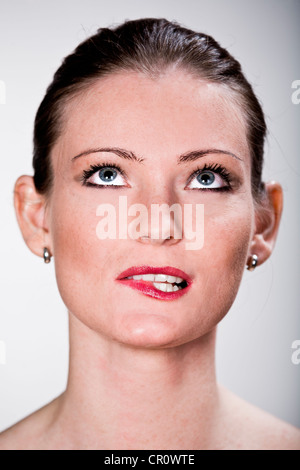 Portrait of a young woman looking sceptical Stock Photo - Alamy