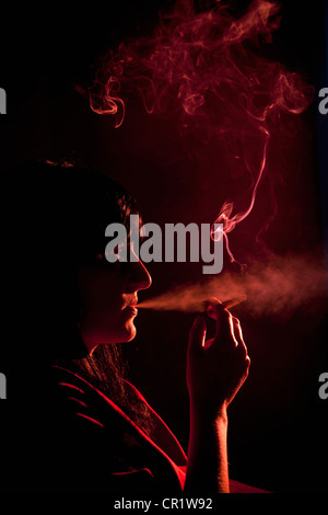 Illuminated profile of woman smoking Stock Photo - Alamy
