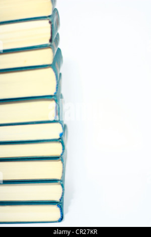 a stack of colorful books in a library or a room isolated on white ...