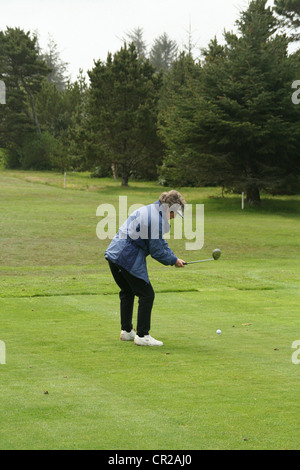 Woman golfer teeing off, Agate Beach Golf Course, Newport, Oregon coast ...