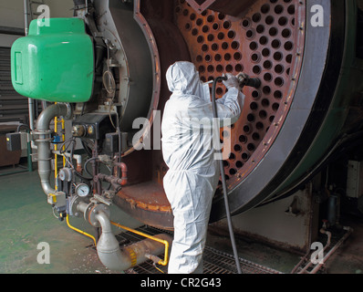Gas main worker in dirty confined space istanding in water pit ...