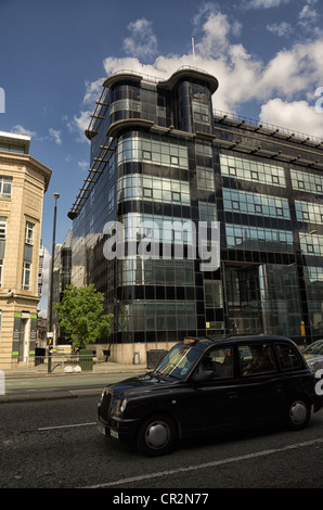 black cab on a manchester city centre street Stock Photo - Alamy