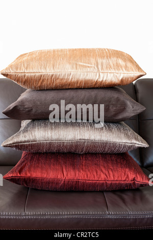 Colorful pillows on a brown leather sofa in a bright space Stock Photo ...