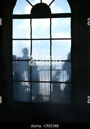 Four silhouettes of people behind of a window Stock Photo - Alamy