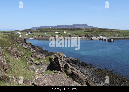 a landscape of port mor isle of muck with boats in the bay and the ...