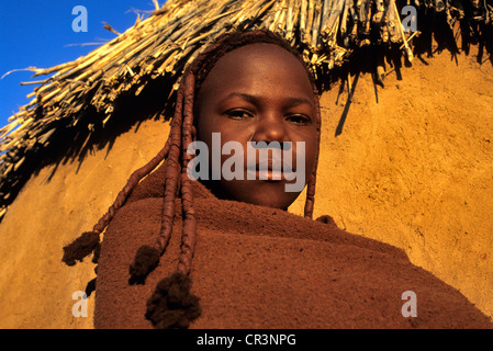 Namibia, Kaokoland. A young Himba girl in traditional attire. Her body ...