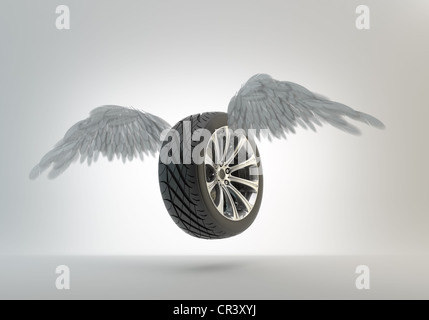 Winged car wheel with a shiny rim Stock Photo - Alamy