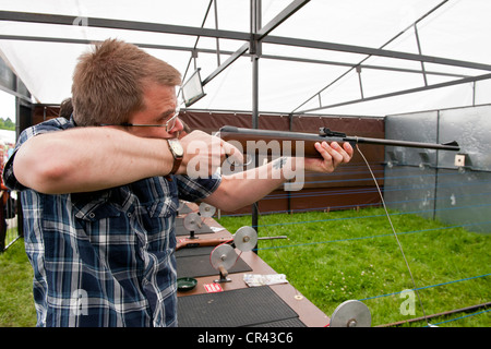 gun air rifle Shooting range gallery at funfair fair fairground with bb ...
