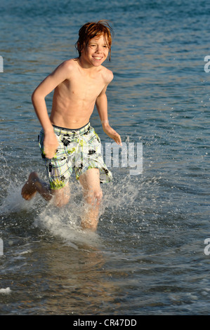 Child joyfully running in water Stock Photo - Alamy