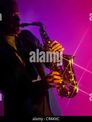 boy play music on saxophone portrait Stock Photo - Alamy