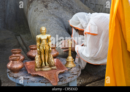 Jain pilgrims are praying at the feet of the gigantic statue of ...
