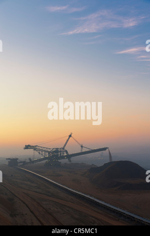 Excavator and spreader in an open-cast mine Stock Photo - Alamy