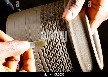 Decoration of a clay pot with ornaments, manufacture of pottery ...