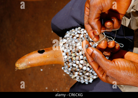 Man producing a traditional hand rattle, Juju Rattles from Klebassen ...