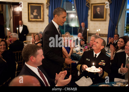 President Barack Obama presents a birthday cake to senior advisor Stock ...