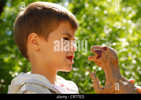 Little boy and Tirannosaurus rex Stock Photo - Alamy