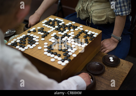 Playing shogi boardgame in a shogi parlor, in Shinsekai district, in ...