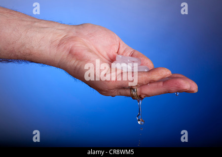 Ice cubes being held in hand and melting Stock Photo - Alamy